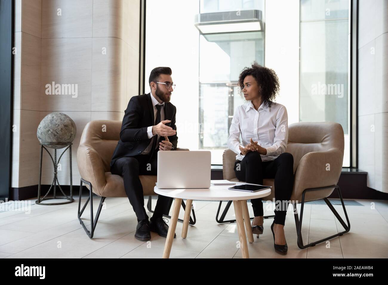 Business colleagues work together analyzing hi-res stock photography ...