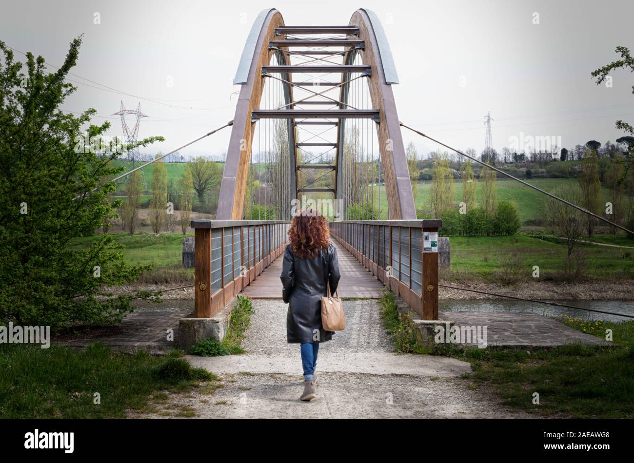 woman back as she's about to cross a bridge Stock Photo - Alamy