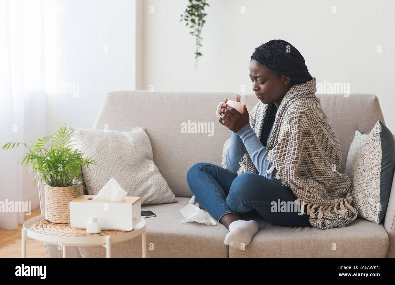Sick Black Girl Drinking Hot Tea On Sofa At Home Stock Photo - Alamy