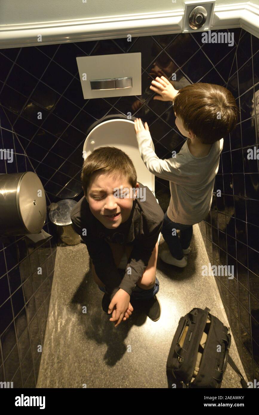 two kids on the toilet (4 and 11 years old Stock Photo - Alamy