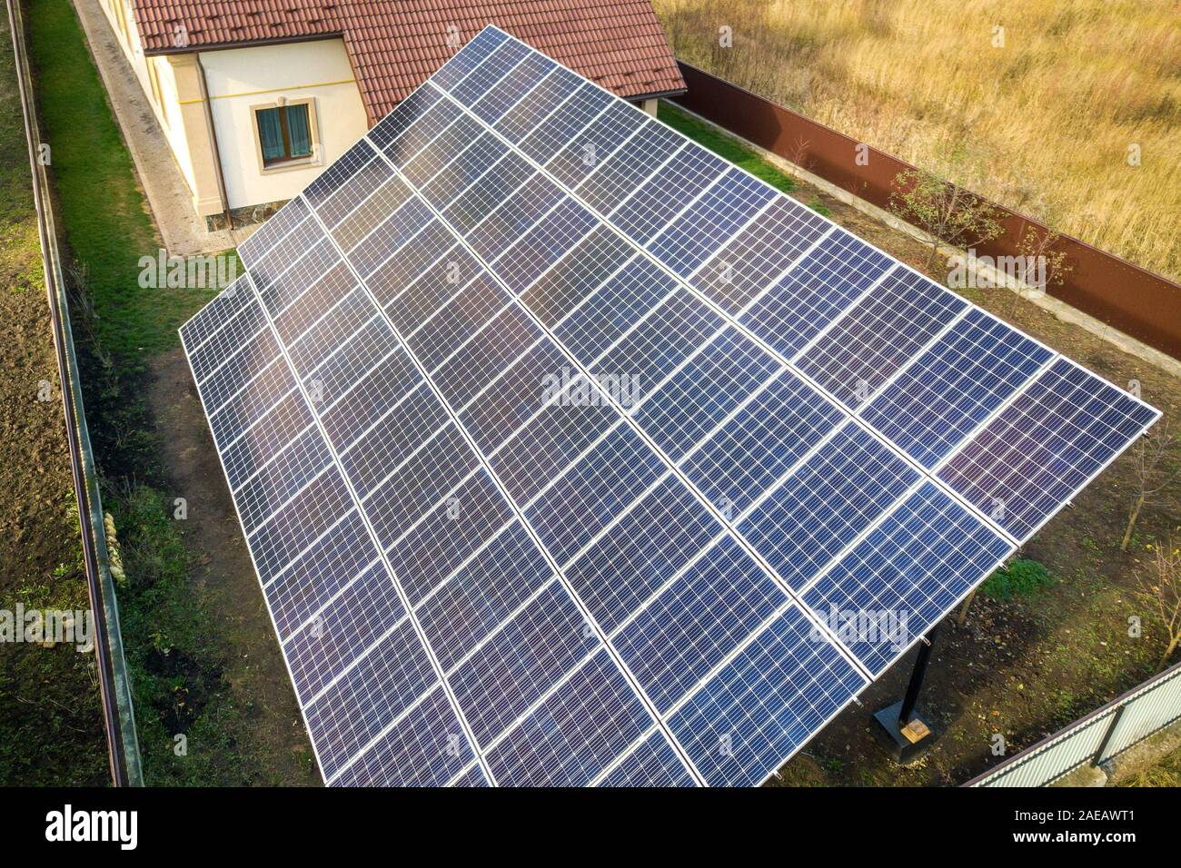 Aerial view of big blue solar panel installed on ground structure near ...