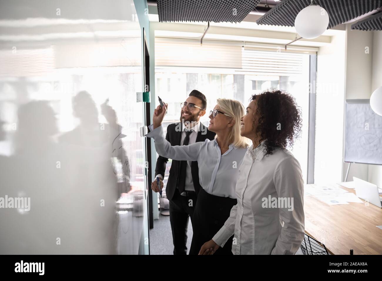 Work group brainstorming on whiteboard hi-res stock photography and ...