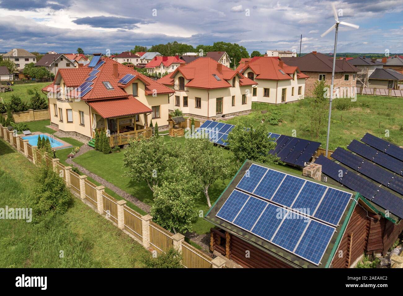 Aerial view of a residential private house with solar panels on roof ...