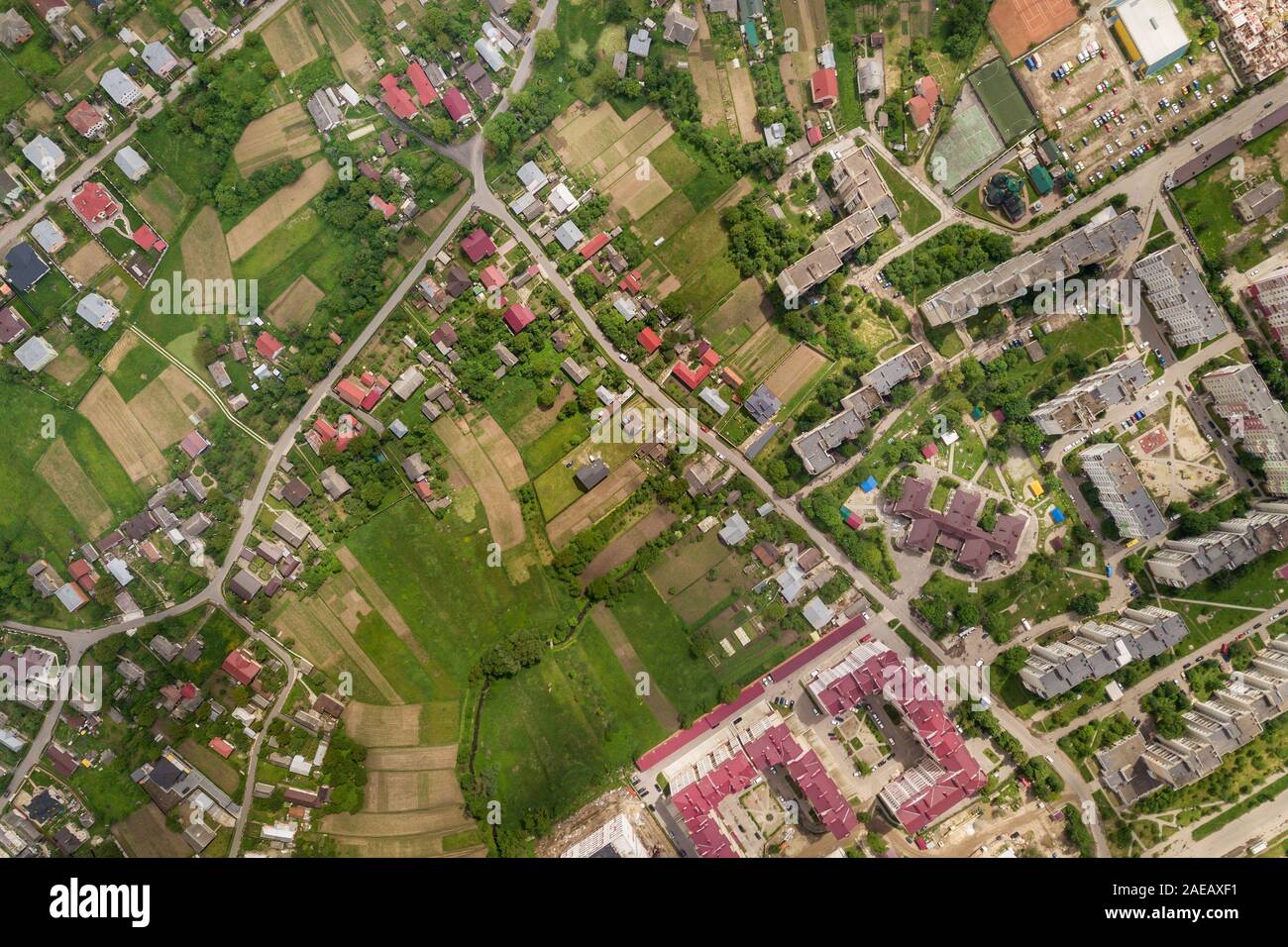Aerial view of town or city with rows of buildings and curvy streets in ...