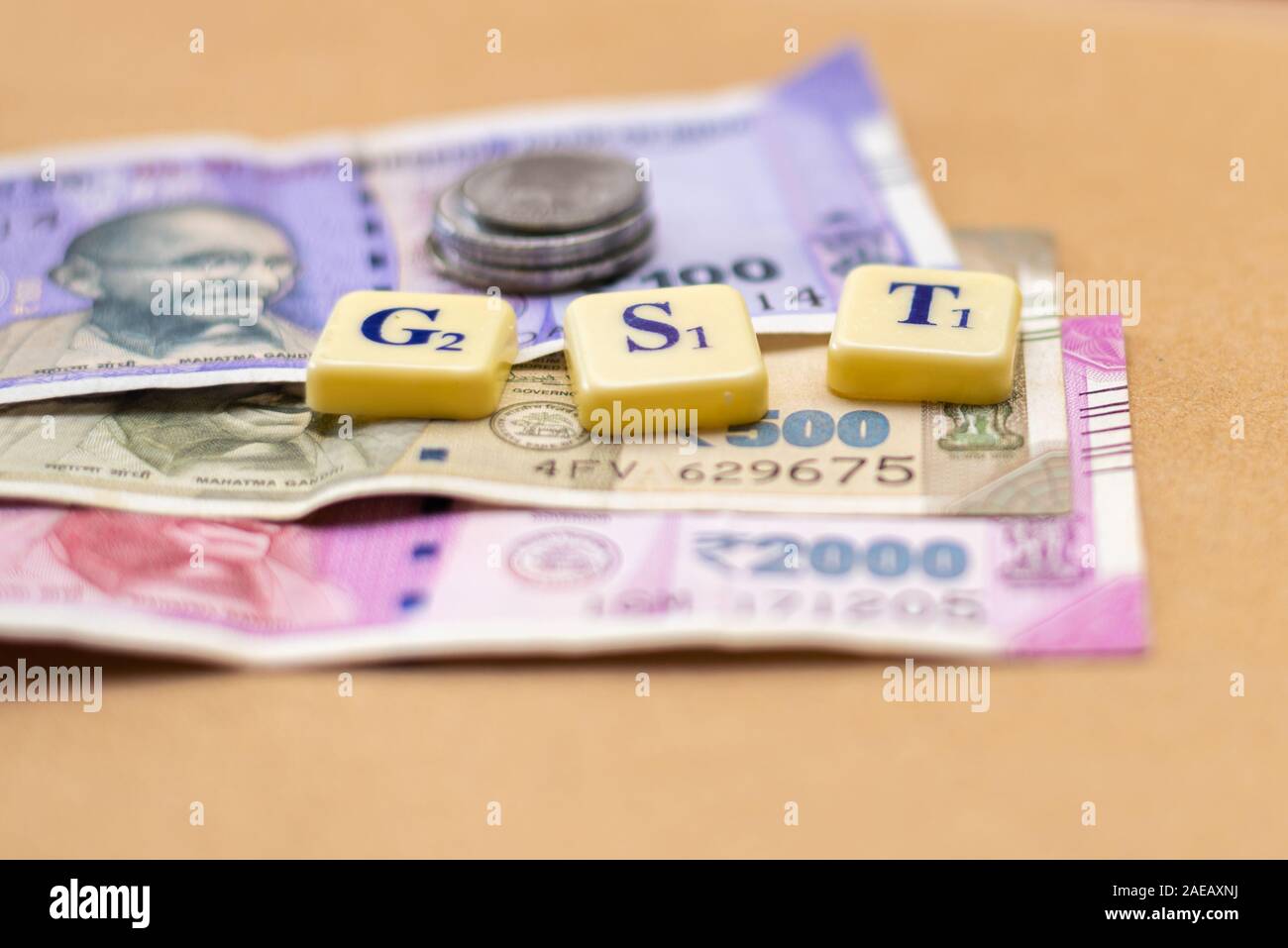 GST and TAX spelt out usingscrabble and indian currency and notes Stock ...