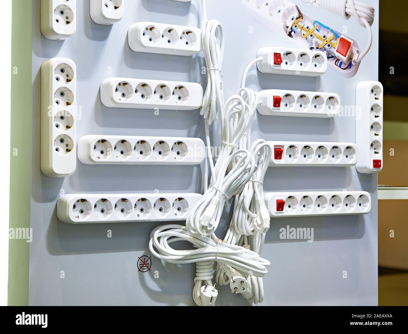 Extension cord and power strip in store Stock Photo - Alamy
