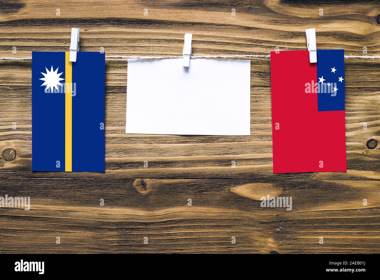 Hanging flags of Nauru and Samoa attached to rope with clothes pins ...