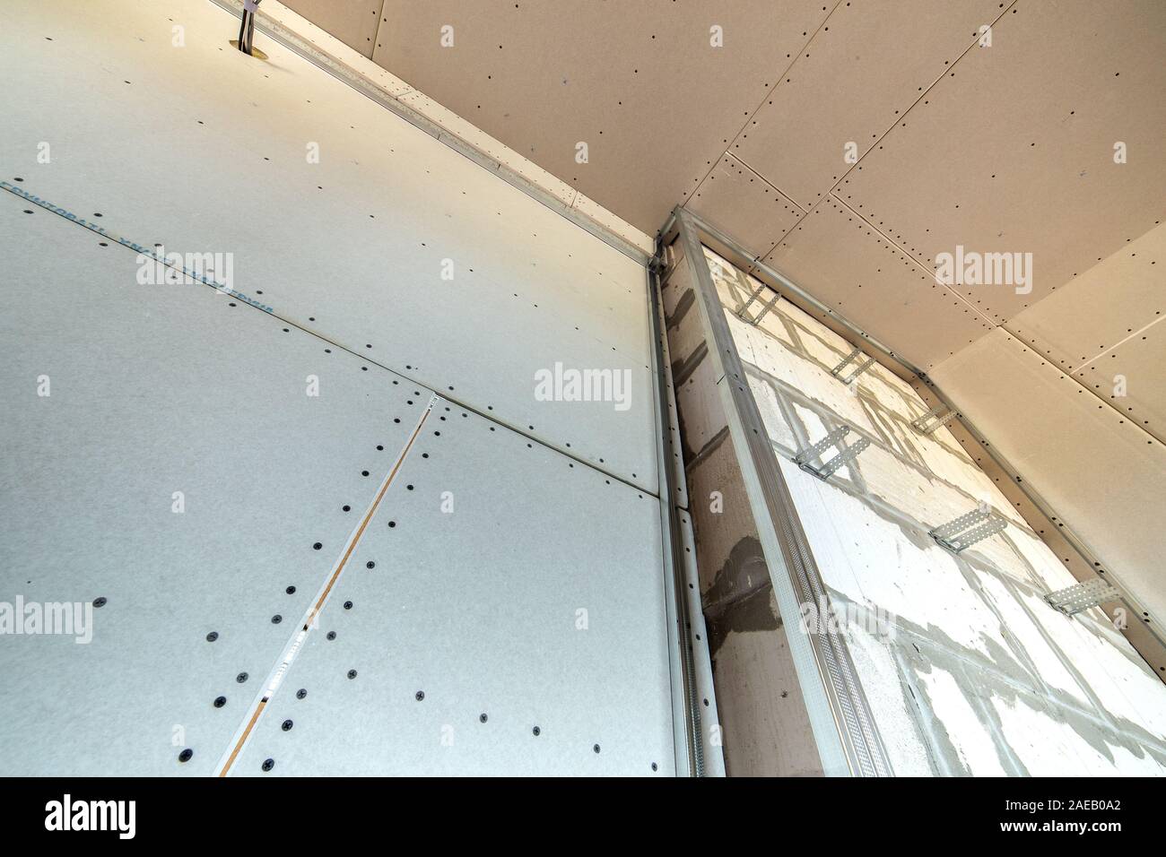 Unfinished brick wall in a room under construction prepared for drywall ...