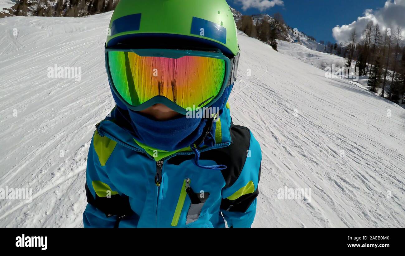 Little boy skiing. A 6 year old child enjoys a winter holiday in the ...