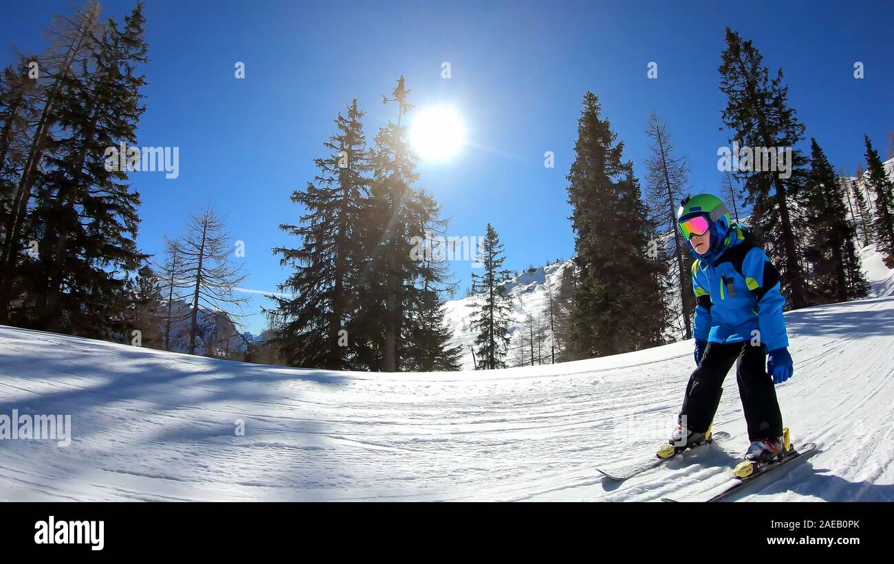 Little boy skiing. A 6 year old child enjoys a winter holiday in the ...