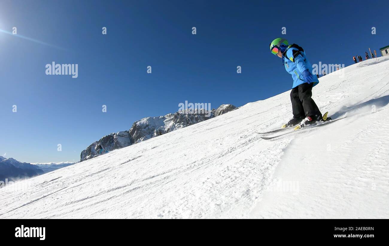 Little boy skiing. A 6 year old child enjoys a winter holiday in the ...