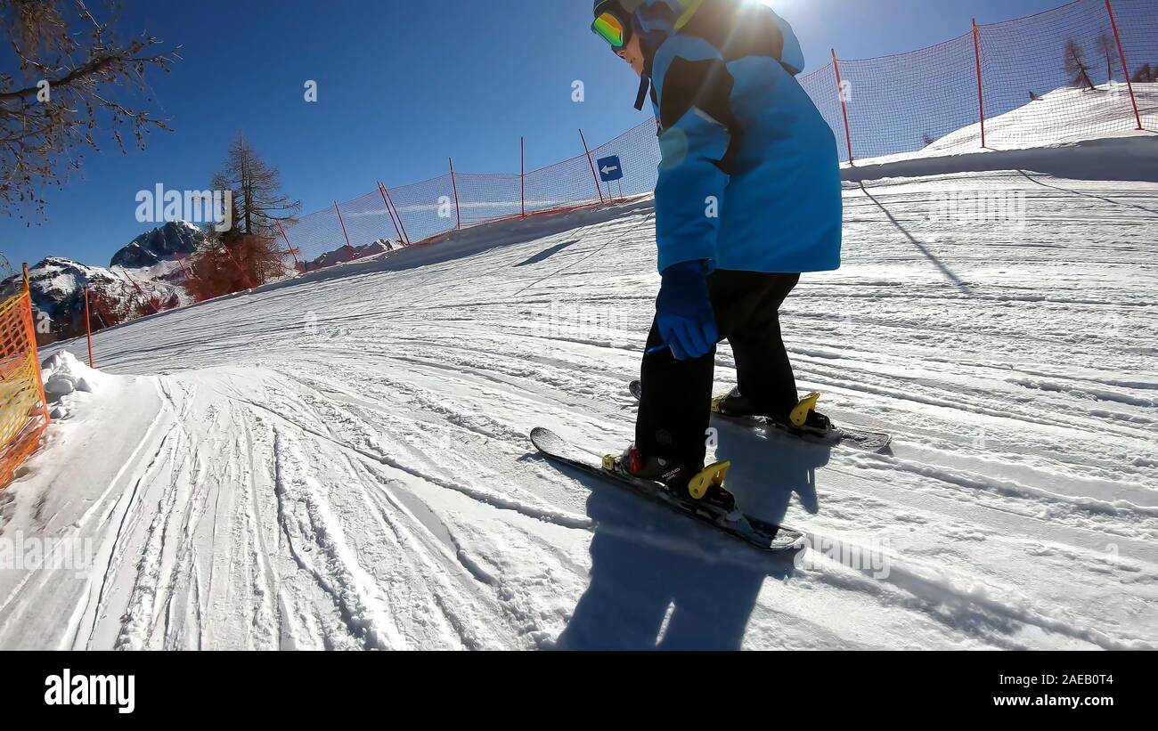 Little boy skiing. A 6 year old child enjoys a winter holiday in the ...