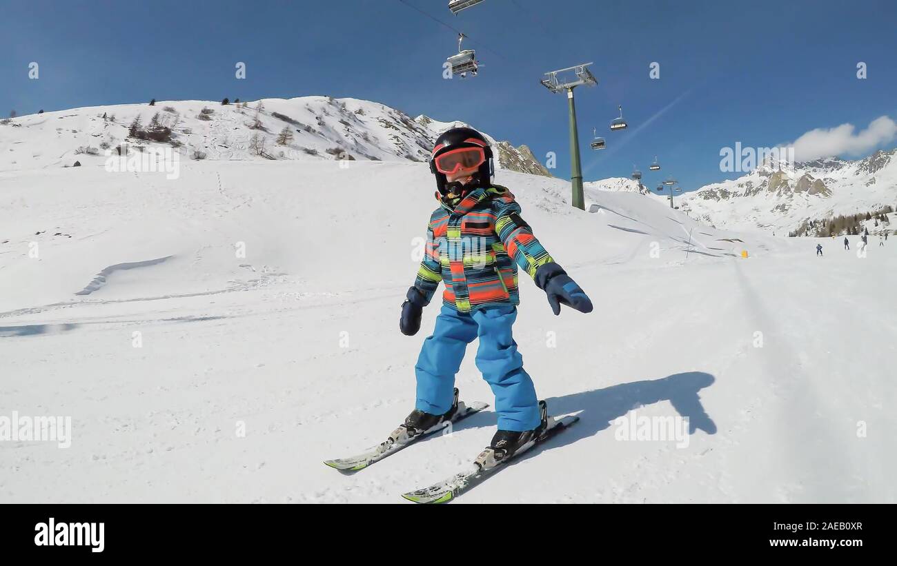 Little boy skiing. A 6 year old child enjoys a winter holiday in the ...