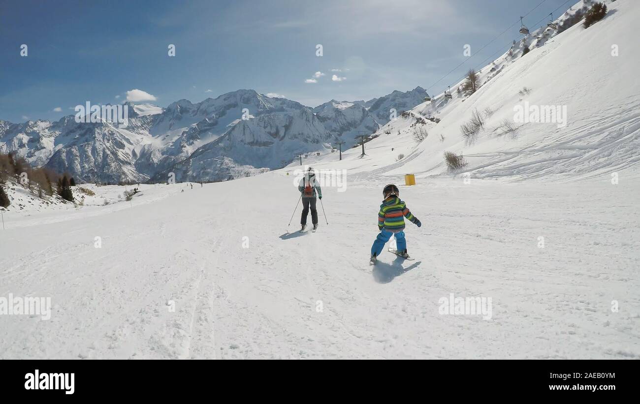 Little boy skiing in the Alpine resort. A 6 year old child enjoys a ...