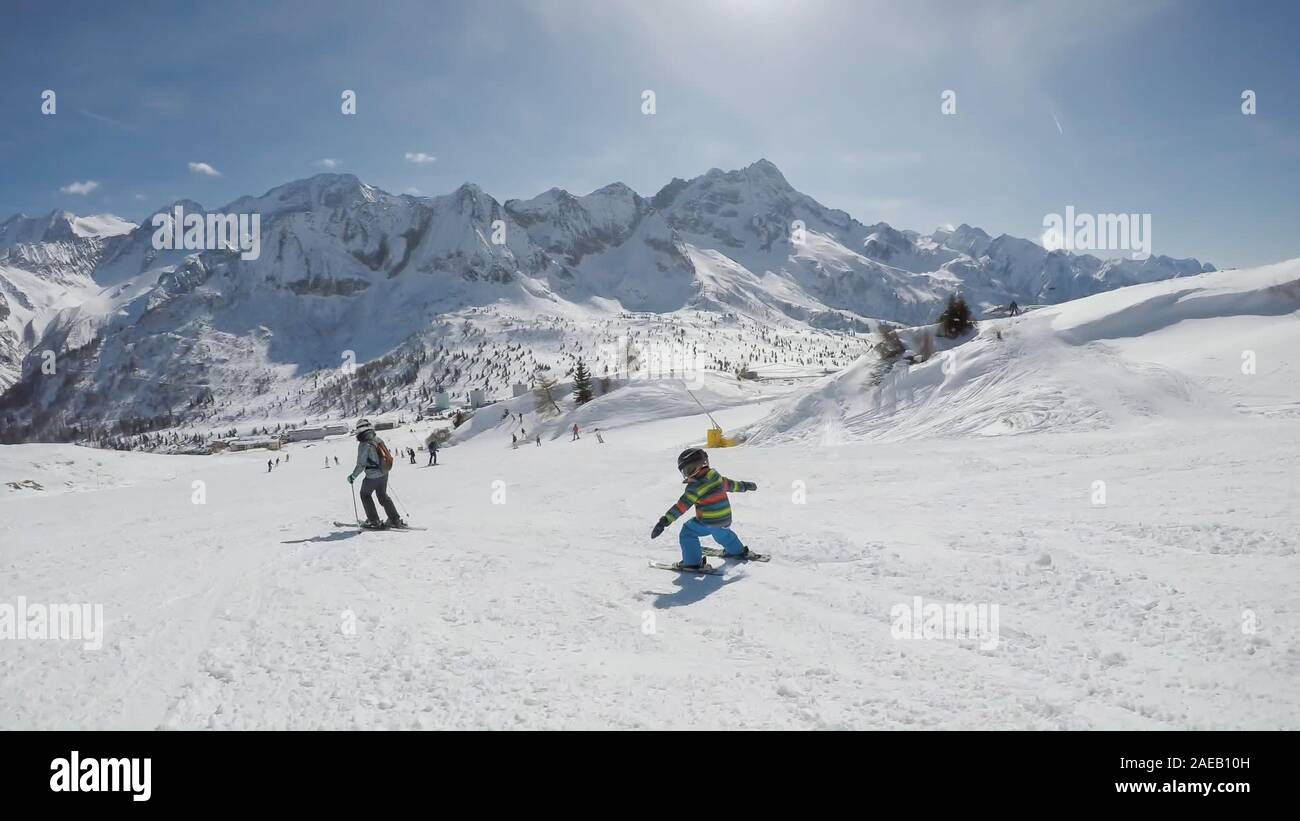 Little boy skiing in the Alpine resort. A 6 year old child enjoys a ...
