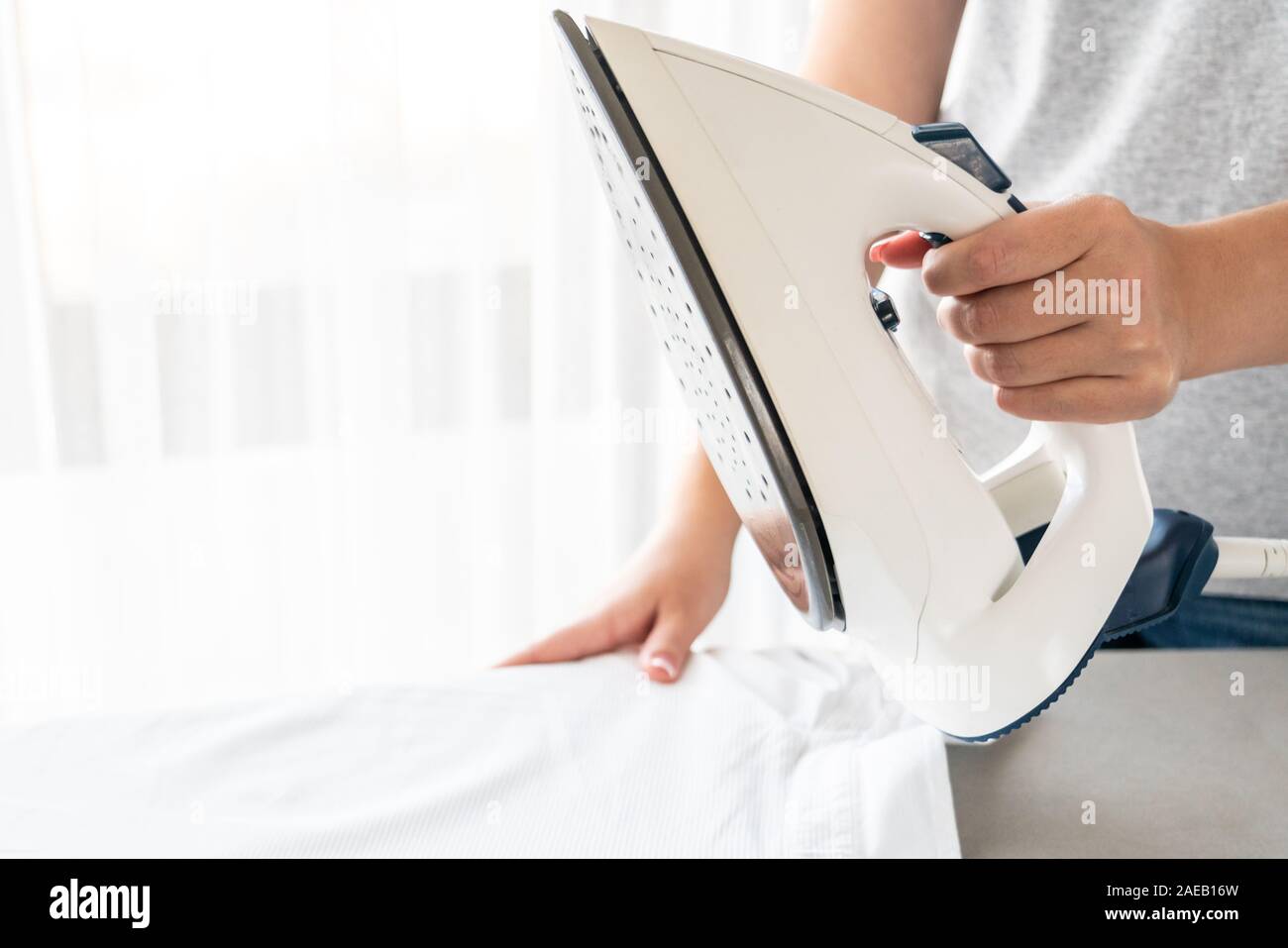 Close up of Female hands ironing white shirt on ironing board Stock ...