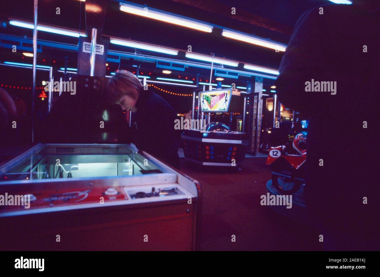 Amusement arcade interior with children playing, in 1970's Yorkshire ...