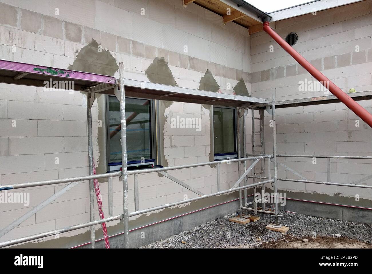 Facade of building made from white blocks with big windows under ...