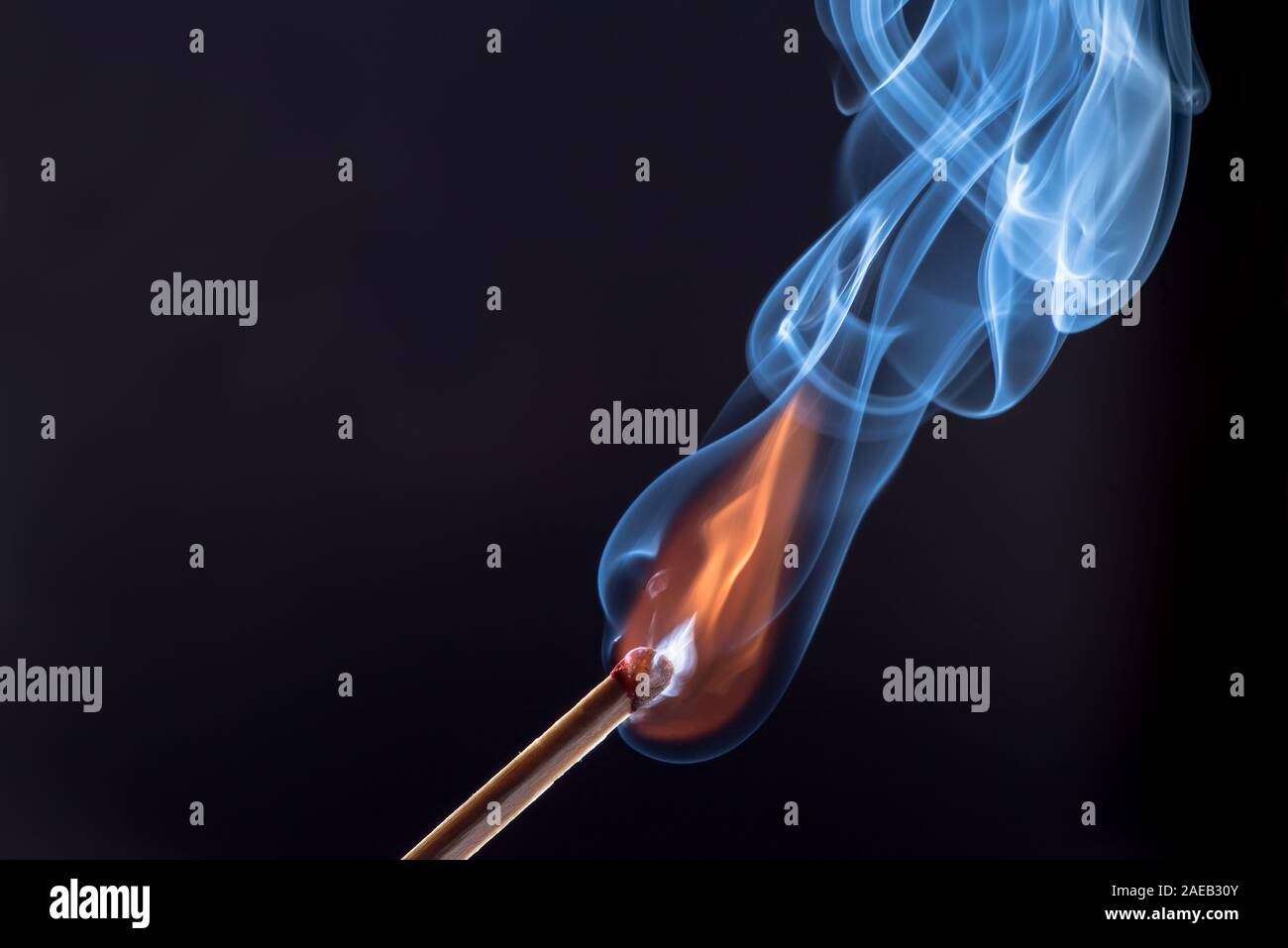 inflaming matchstick with blue smoke - high speed image Stock Photo - Alamy