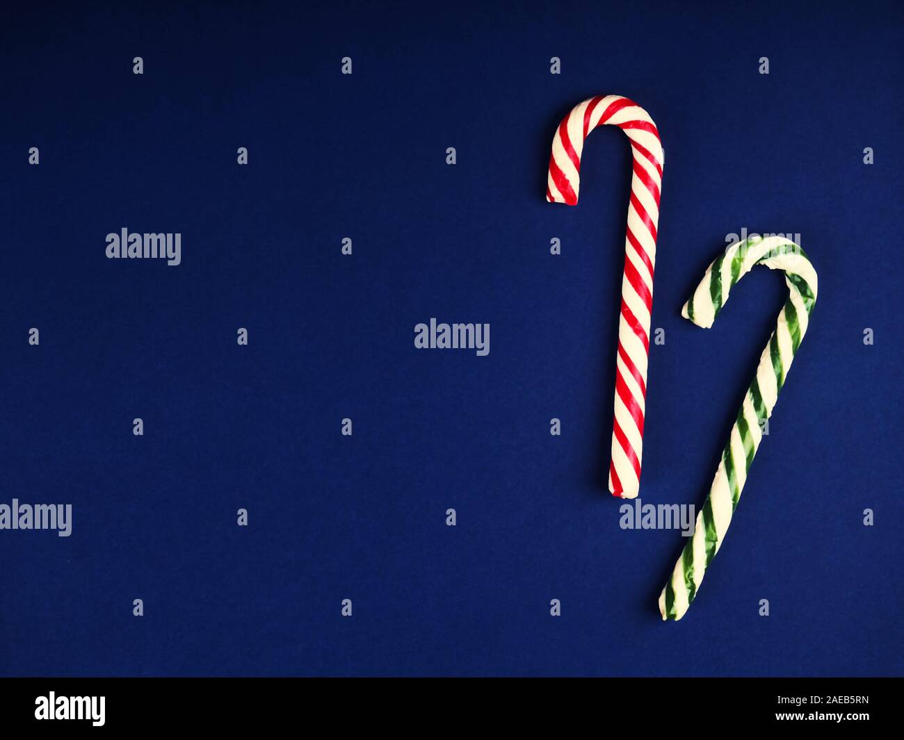 Christmas candy cane. On classic blue background. Flat lay. Christmas ...