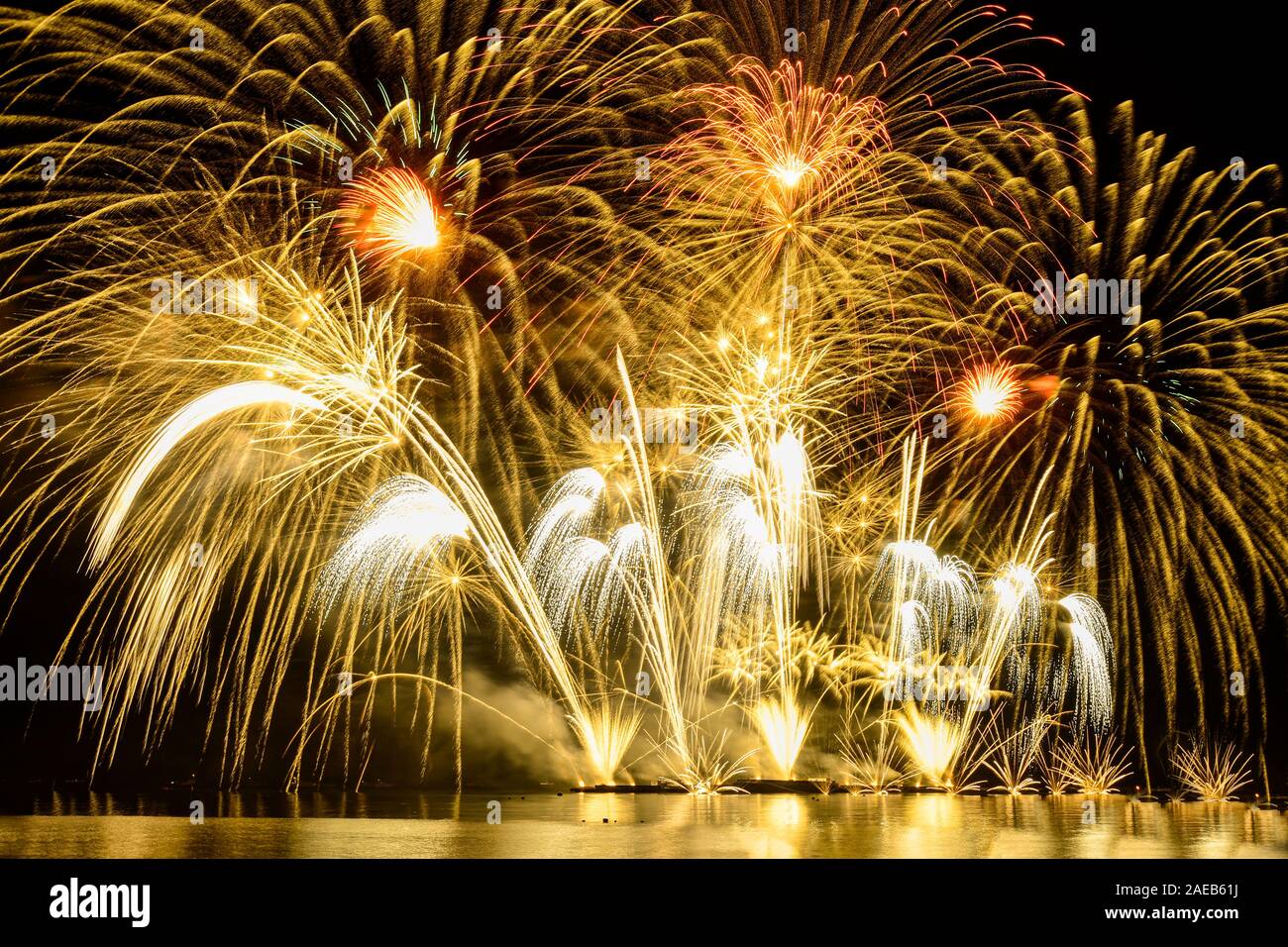Gold fireworks background. Frieworks celebration on the dark sky over ...