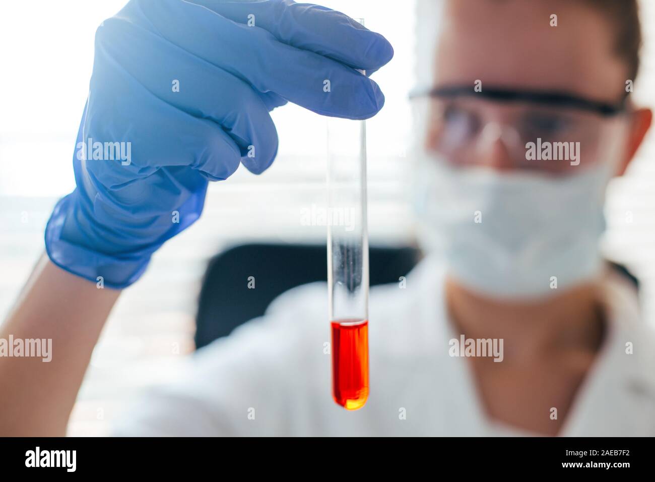 Chemist checking test tube in laboratory Stock Photo - Alamy