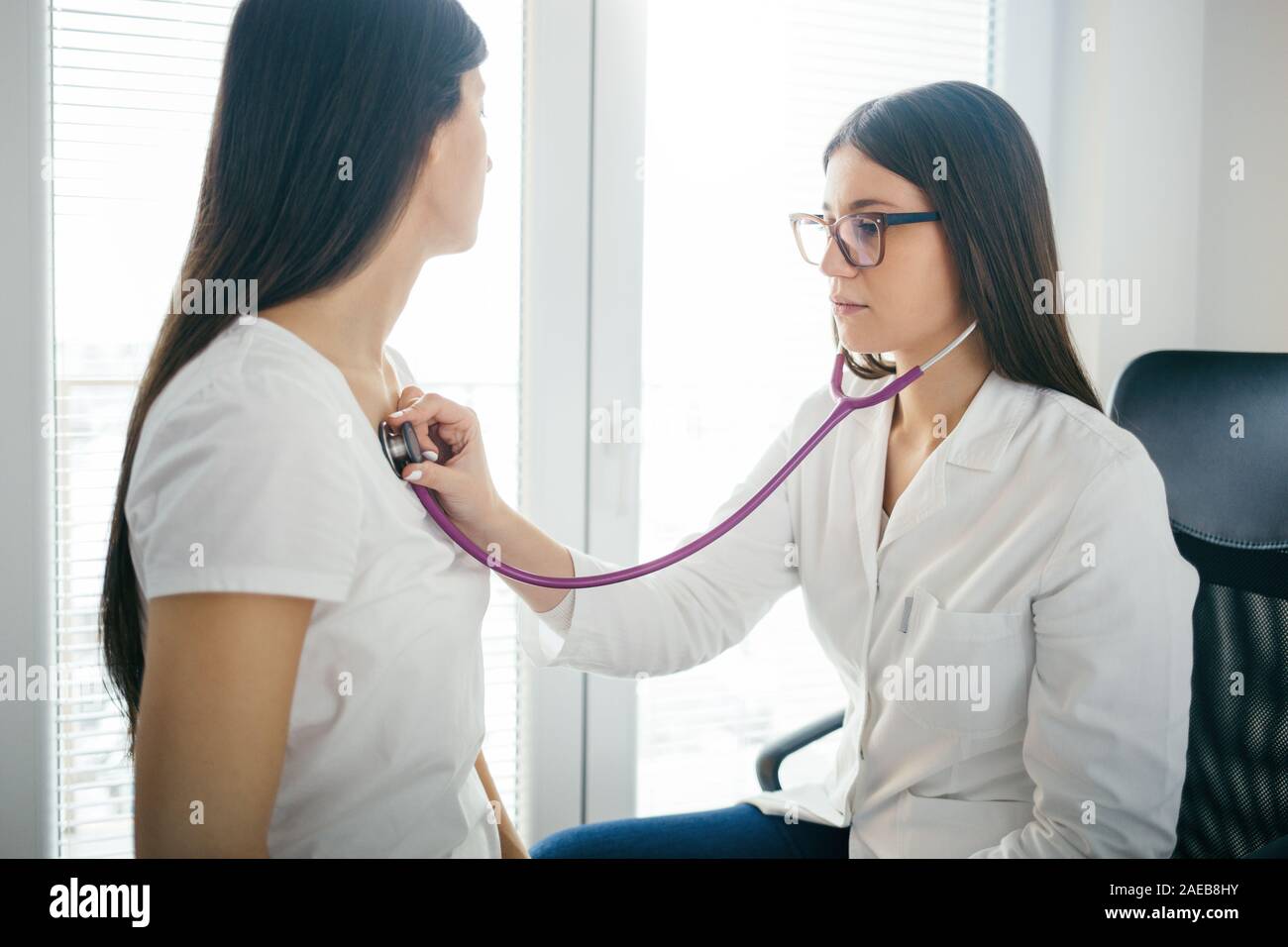 Doctor listening patient with stethoscope Stock Photo - Alamy