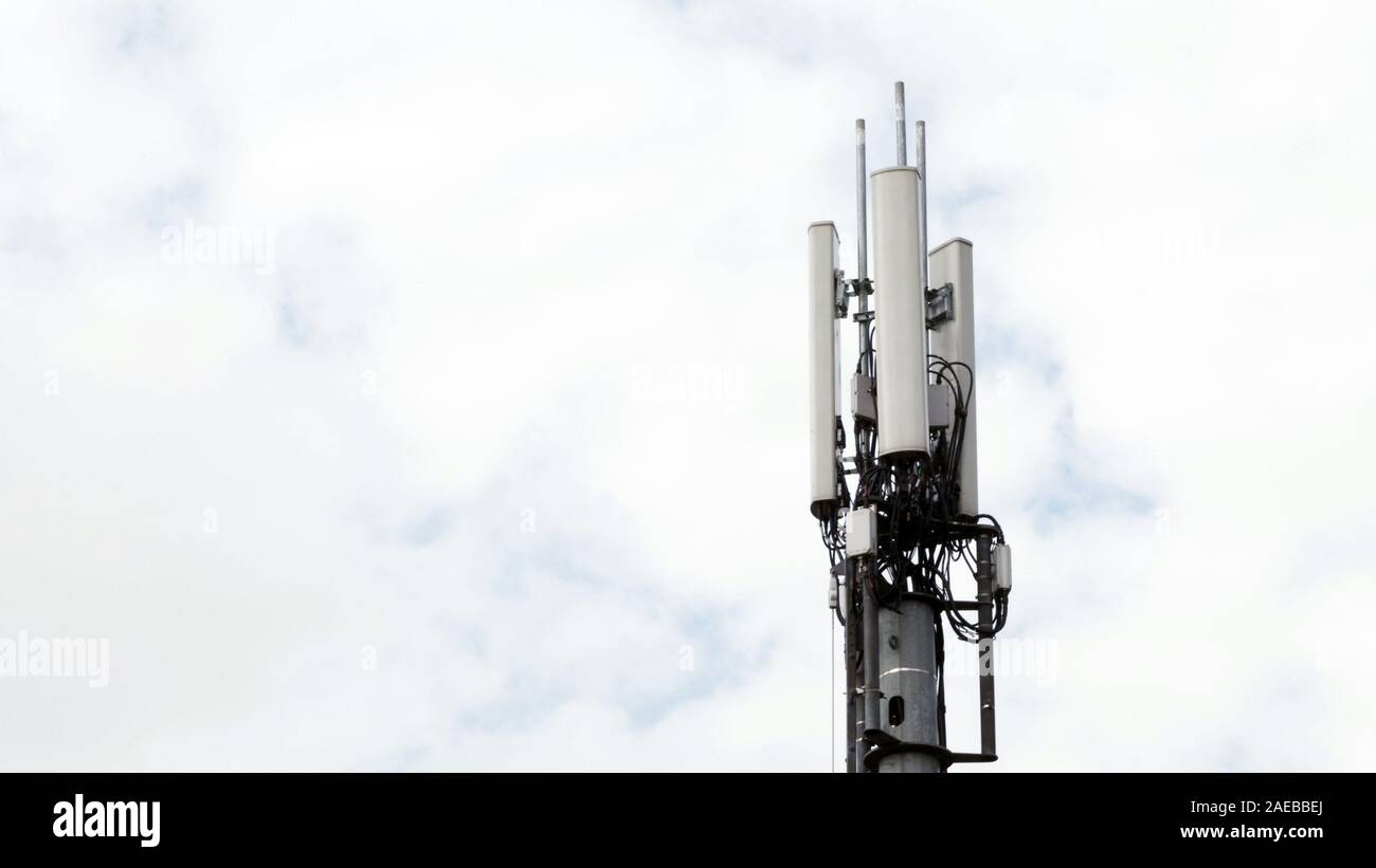 mobile network tower mast over slow moving cloudy background in england ...