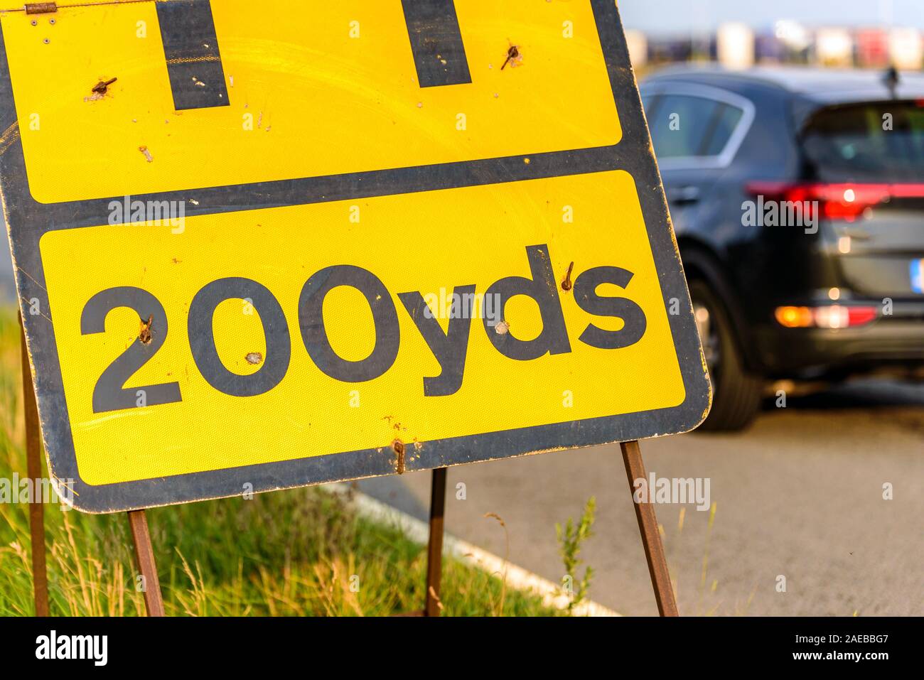 200 yards roadworks warning sign on UK motorway at evening with traffic ...