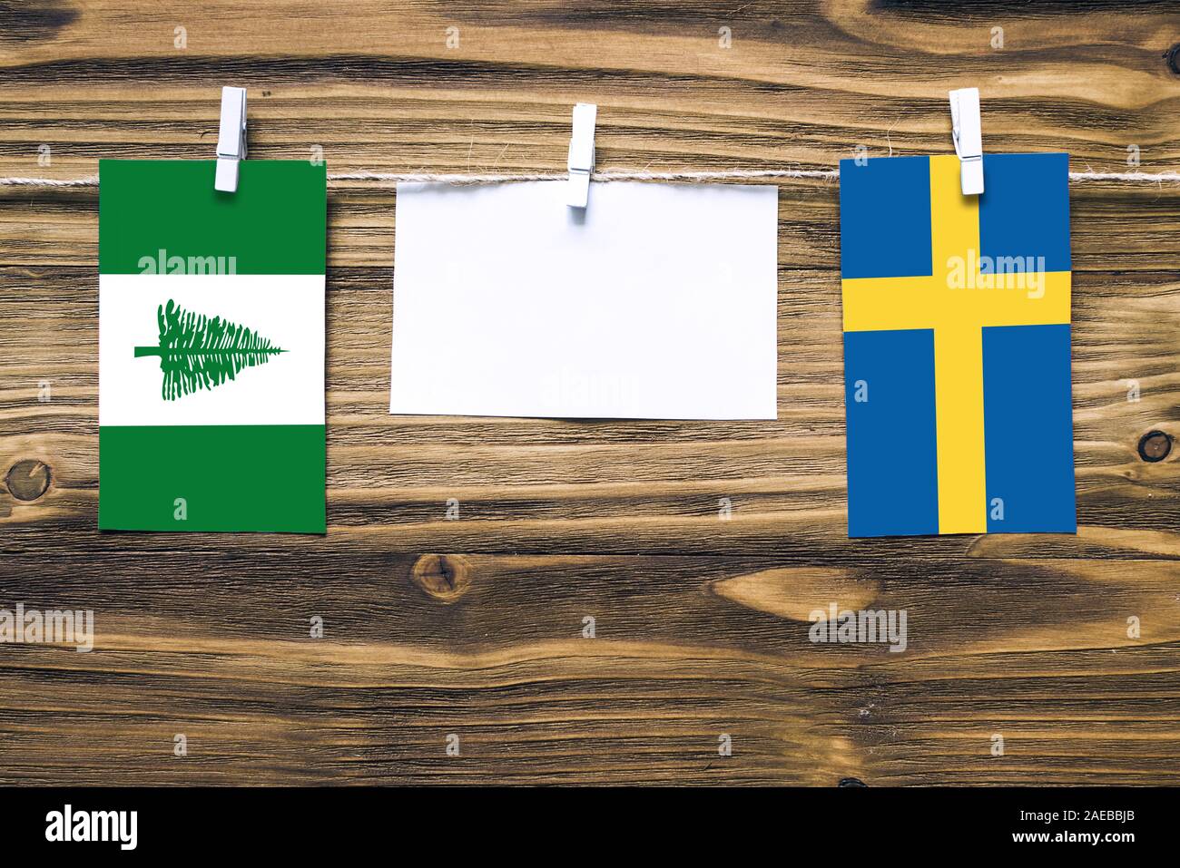 Hanging flags of Norfolk Island and Sweden attached to rope with ...