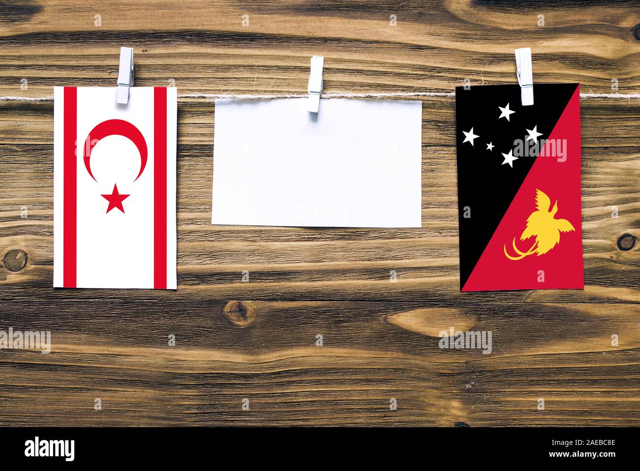 Hanging flags of Northern Cyprus and Papua New Guinea attached to rope ...