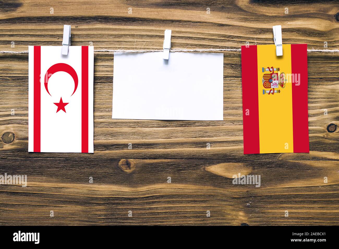 Hanging flags of Northern Cyprus and Spain attached to rope with ...