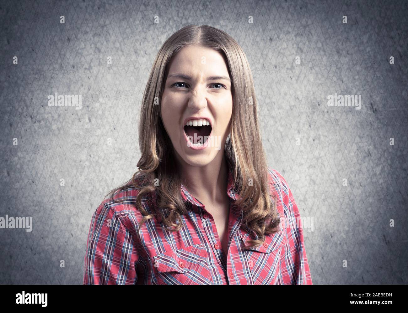 Frenzied young woman screaming with anger Stock Photo - Alamy