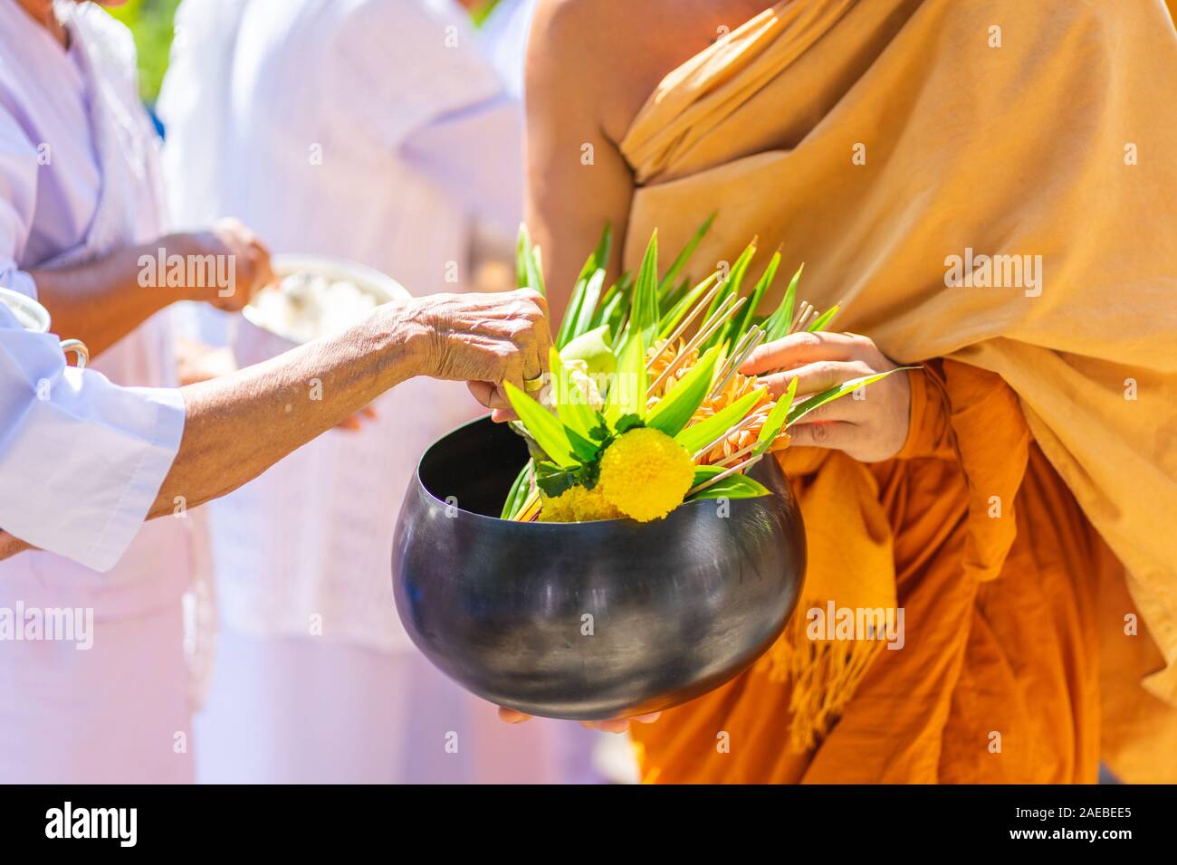 People giving offerings to monk hi-res stock photography and images - Alamy