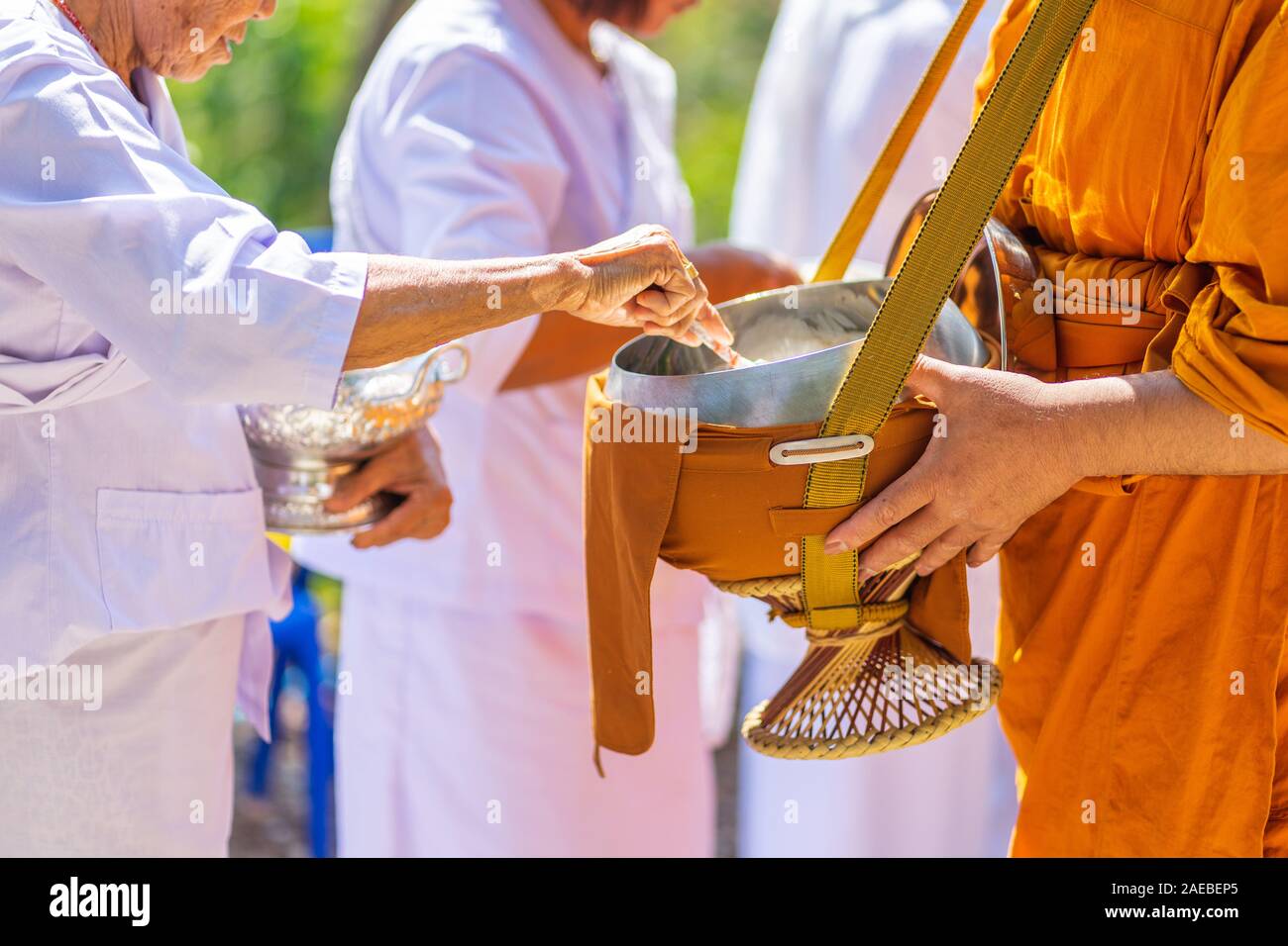 People giving offerings to monk High Resolution Stock Photography and ...