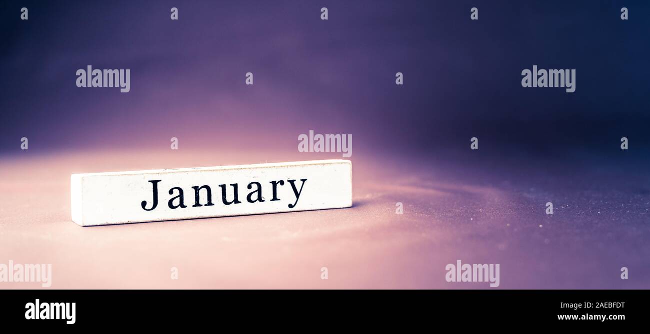 January, name of the month written on vintage white wooden block on ...