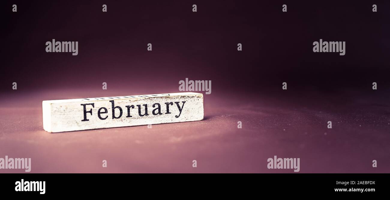 February, name of the month written on vintage white wooden block on ...