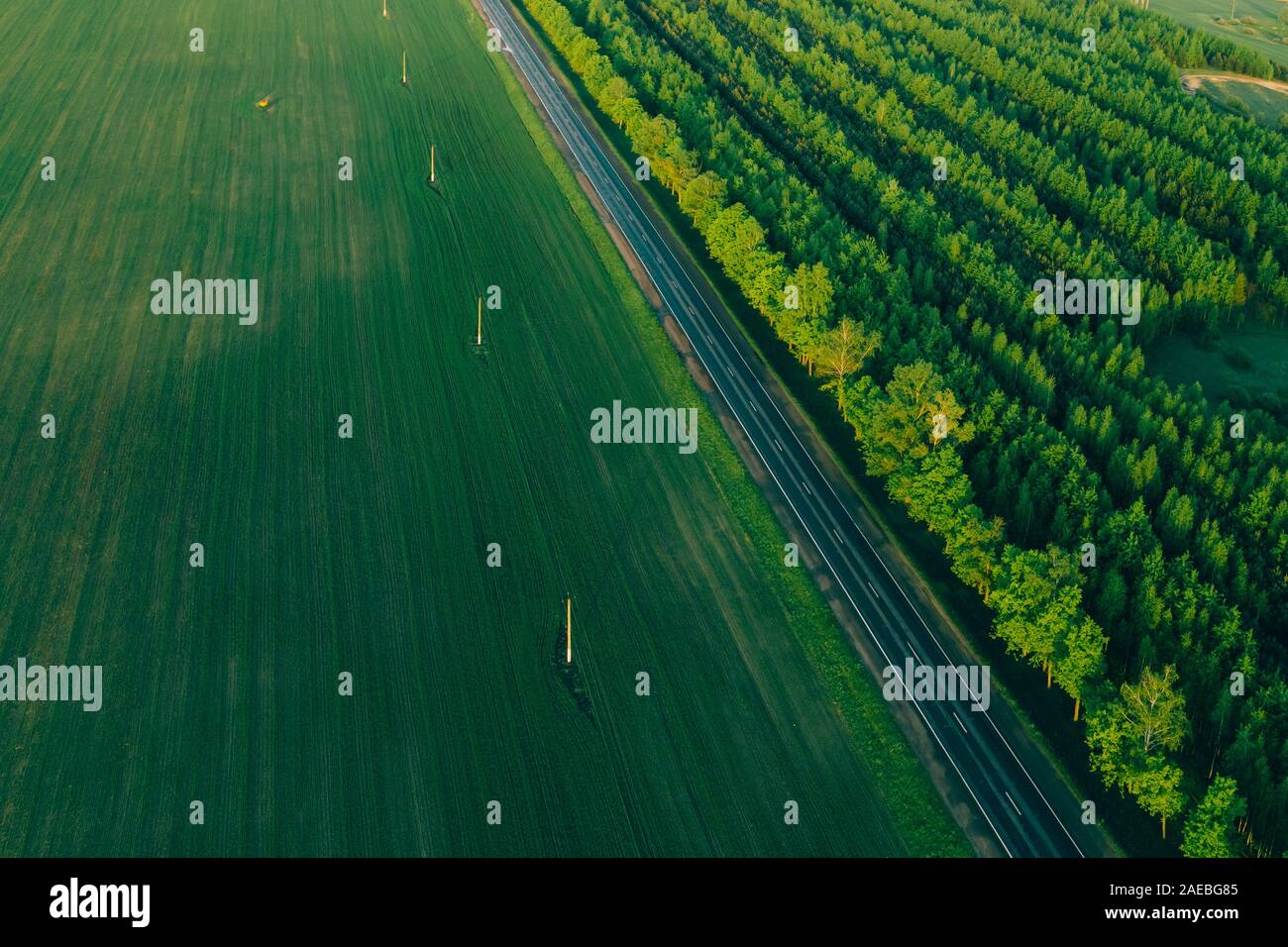 Aerial view - A beautiful flat highway in a field on one side and ...