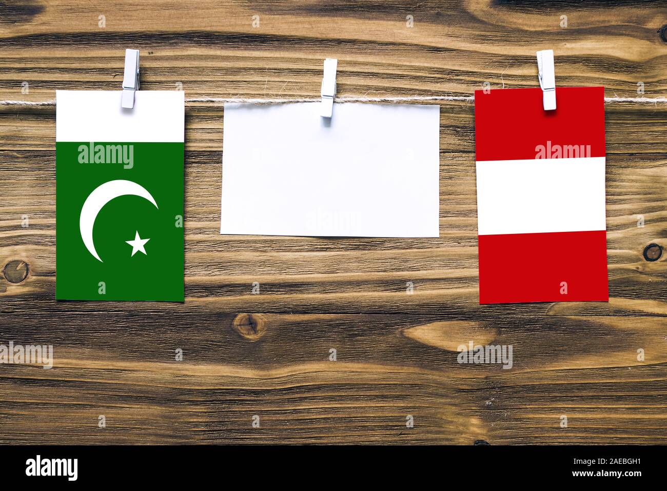Hanging flags of Pakistan and Peru attached to rope with clothes pins ...