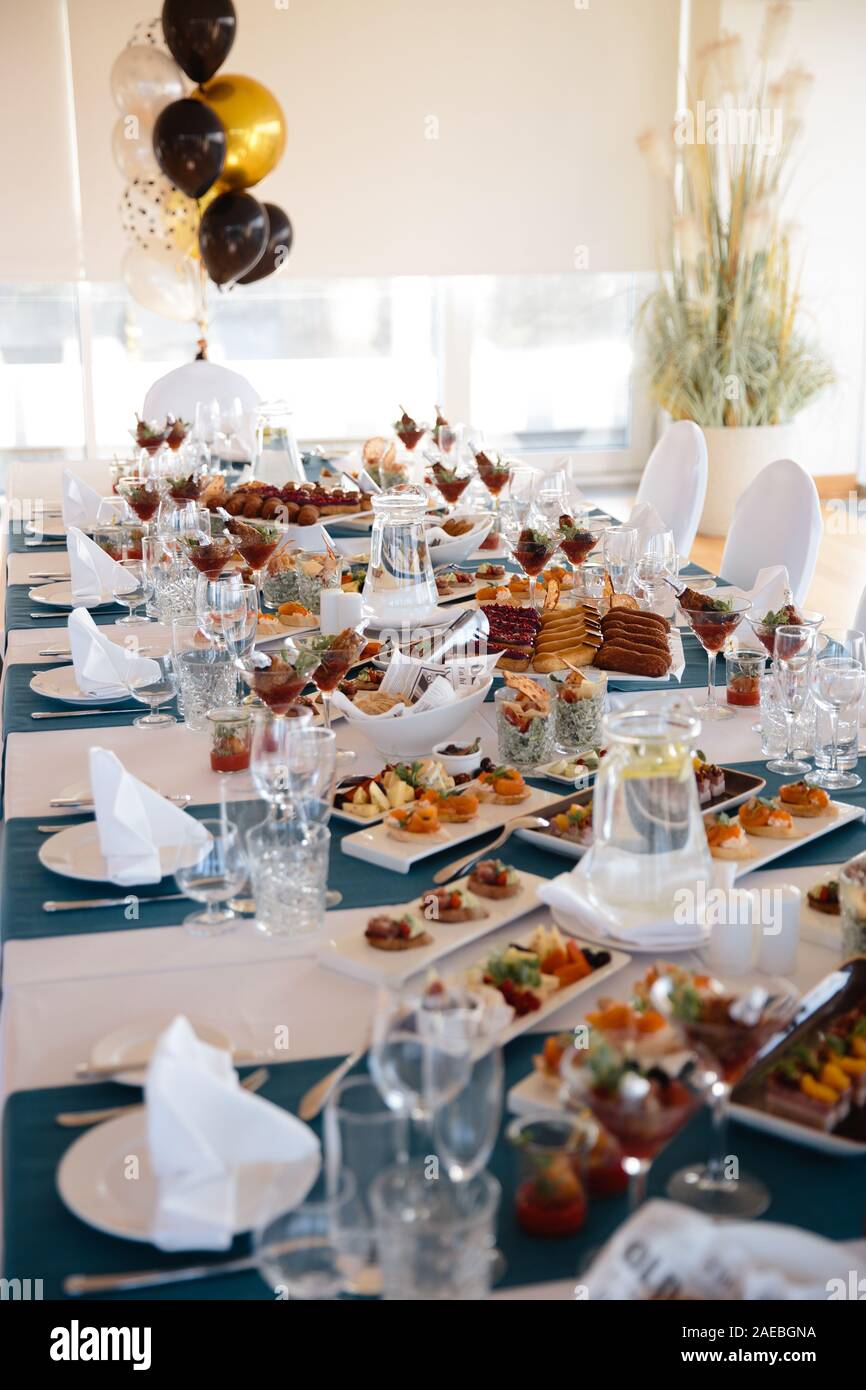 Food served on table in a white hall during a Birthday party in Eastern ...
