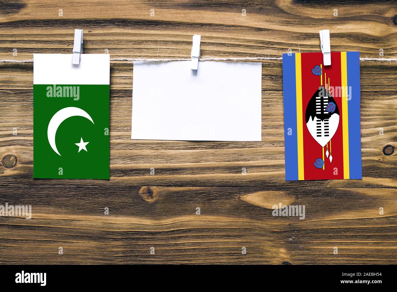 Hanging flags of Pakistan and Swaziland attached to rope with clothes ...