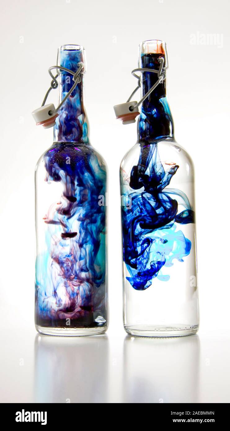 Two bottles with blue smoke Stock Photo - Alamy