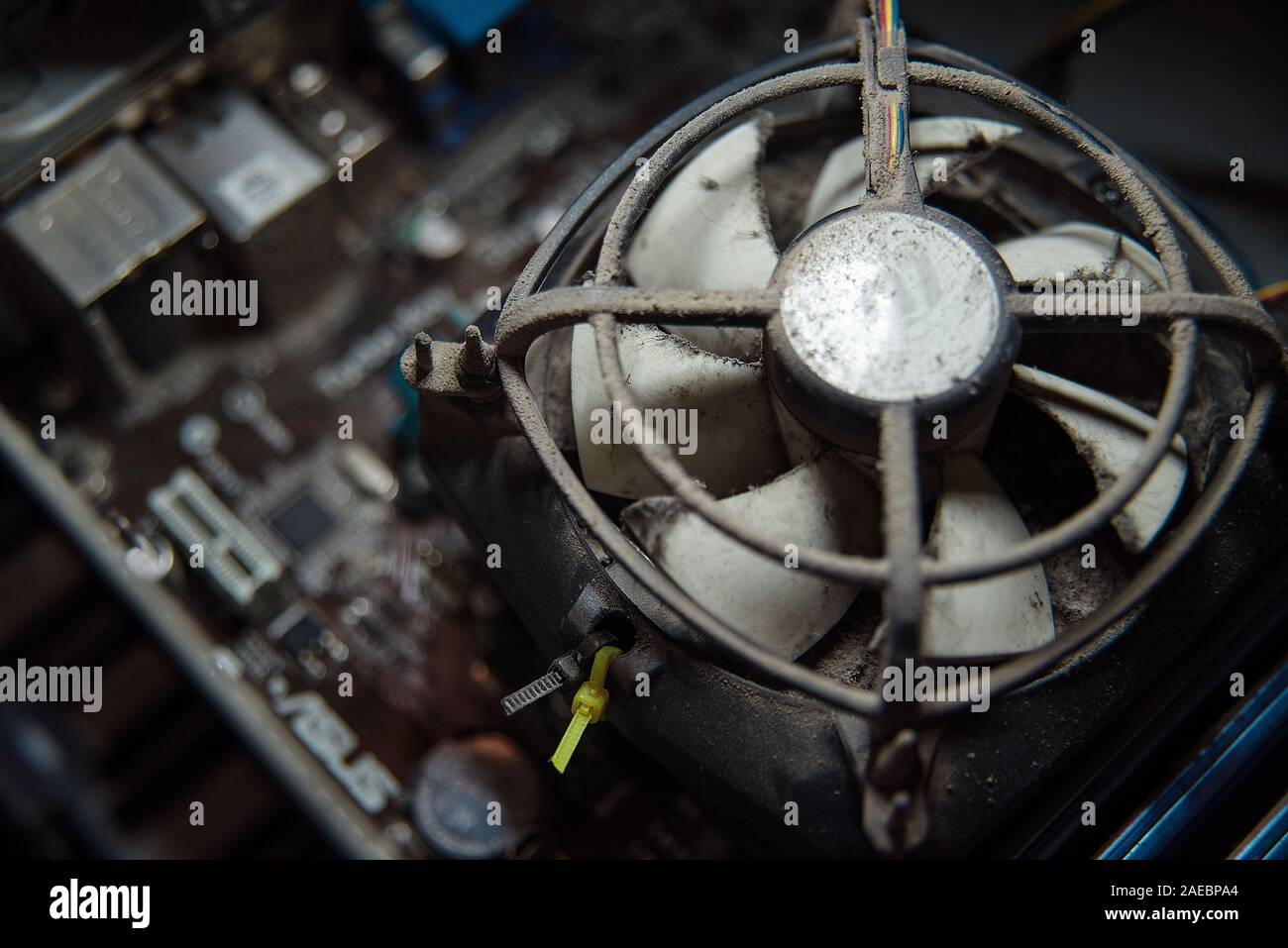Dust on computer pc processor cooler with mainboard and computer case fragment. Selective focus ...