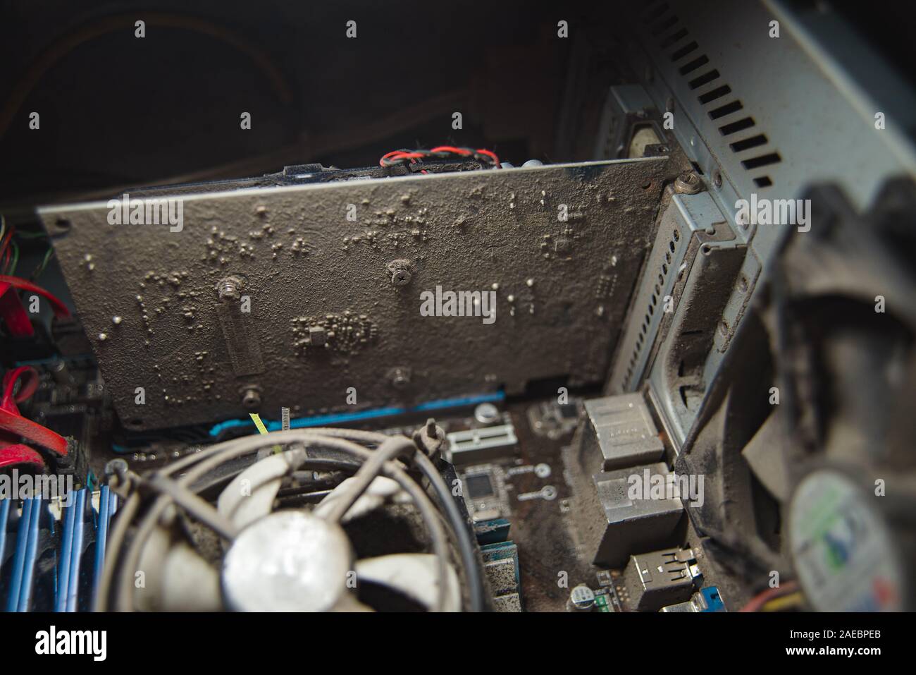 Dust on computer pc processor cooler with mainboard and computer case fragment. Selective focus ...