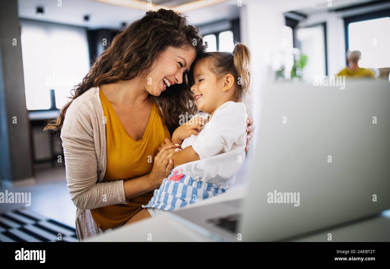 Mother at home trying to work with child distracting her Stock Photo ...