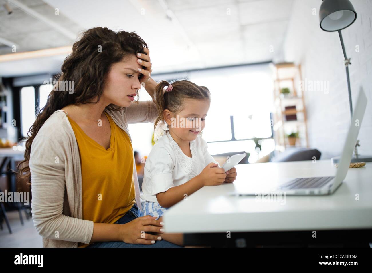 Tired stressed out mom with game and technology addicted child Stock ...