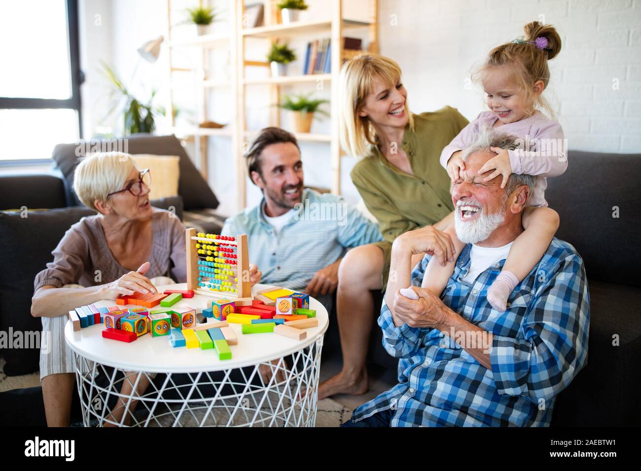 Senior grandparents playing with grandchildren and having fun with ...