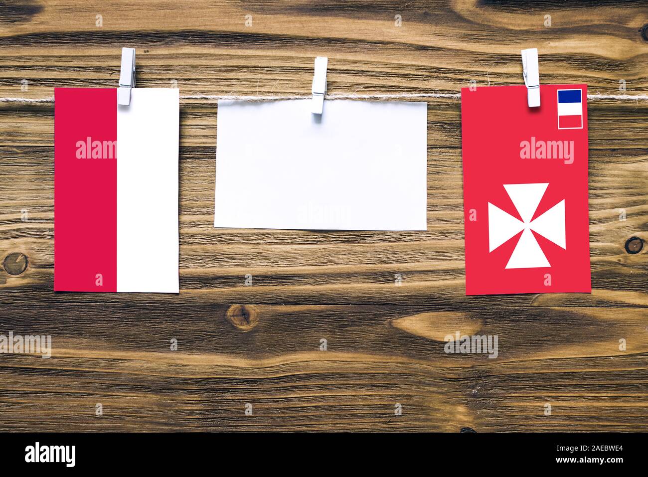 Hanging flags of Poland and Wallis And Futuna attached to rope with ...