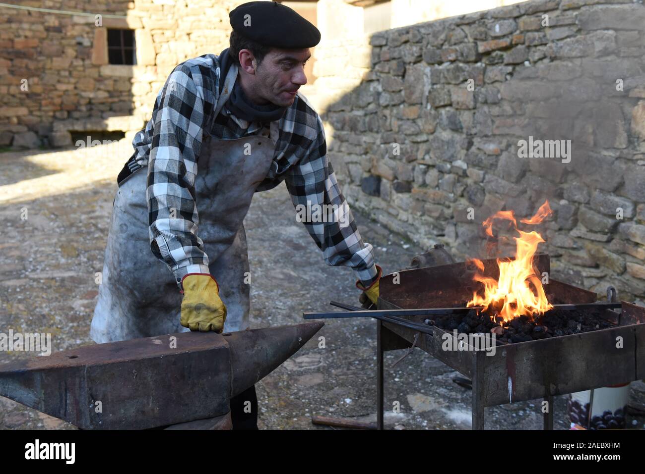 A man portrays a blacksmith during the live nativity scene in the small ...