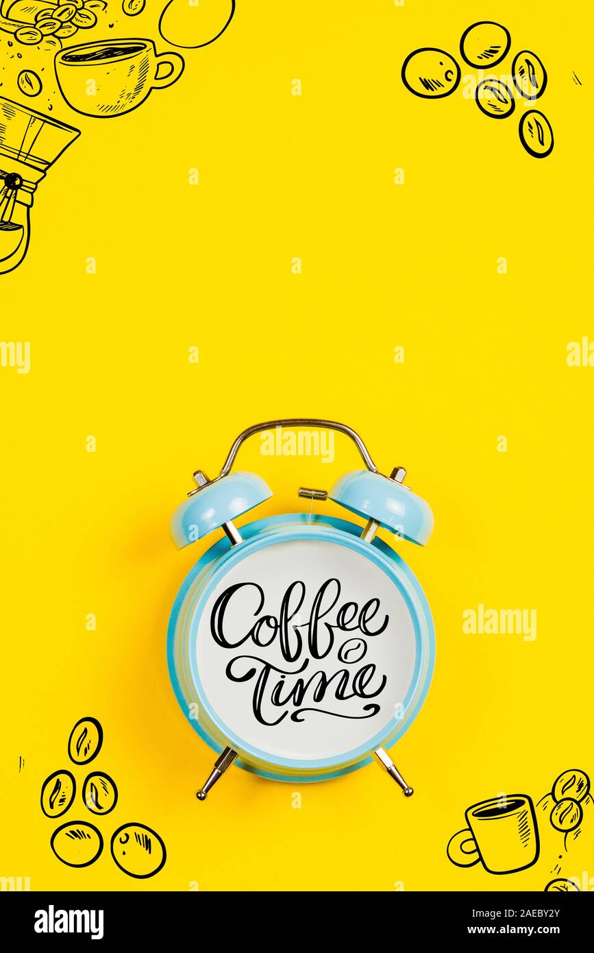 Blue alarm clock with graphics and text Coffee time on a yellow ...